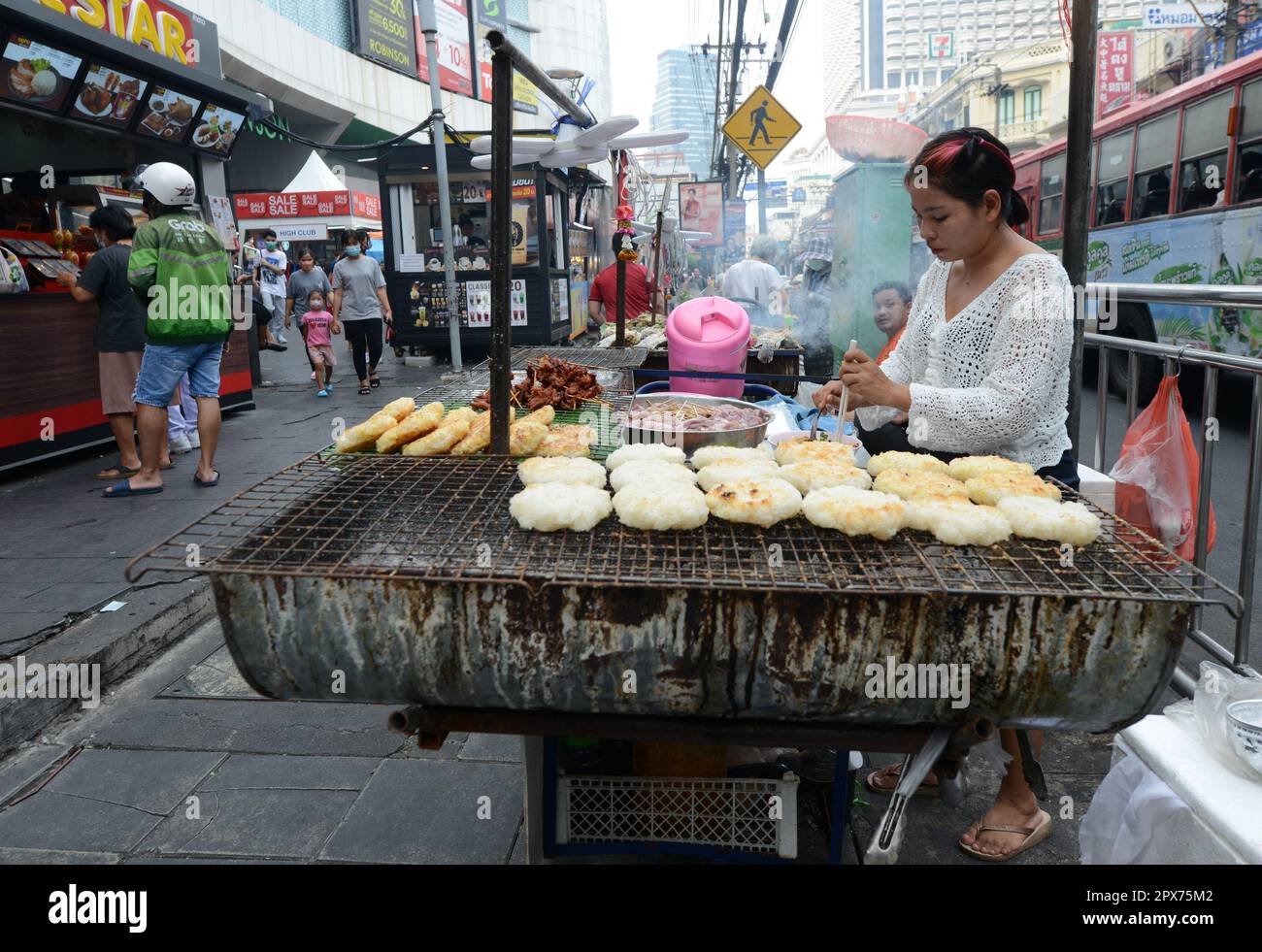 A grilled sticky rice vendor on Charoen Krung Road in Bang Rak, Bangkok ...