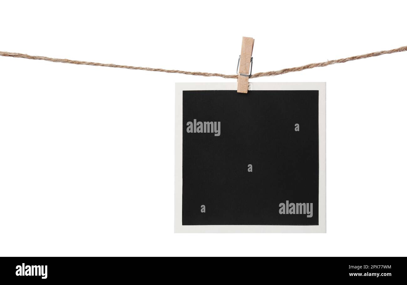 Clothespin with empty instant frame on string against white background ...