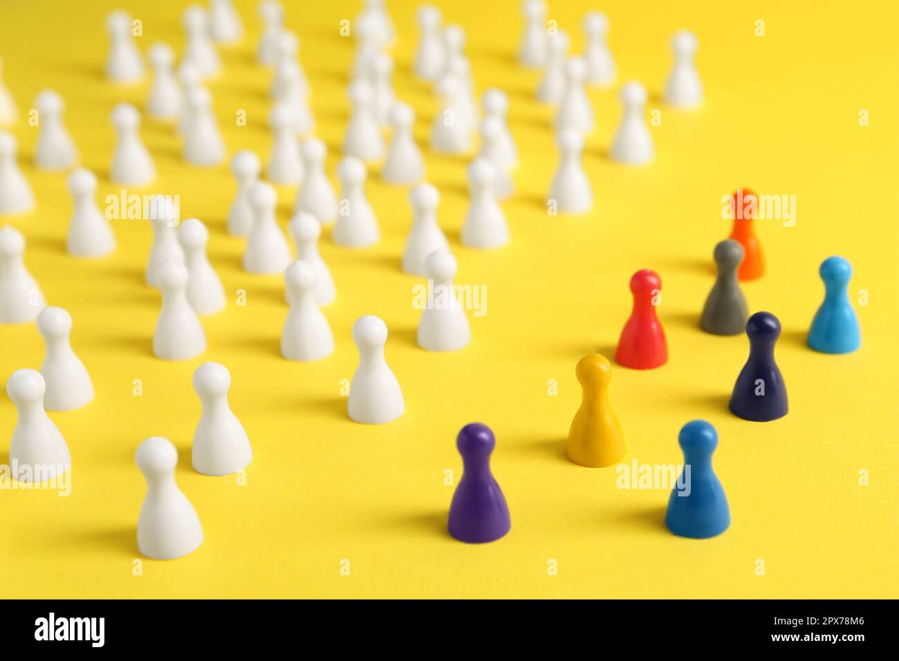 Colorful pawns on yellow background. Social inclusion concept Stock ...