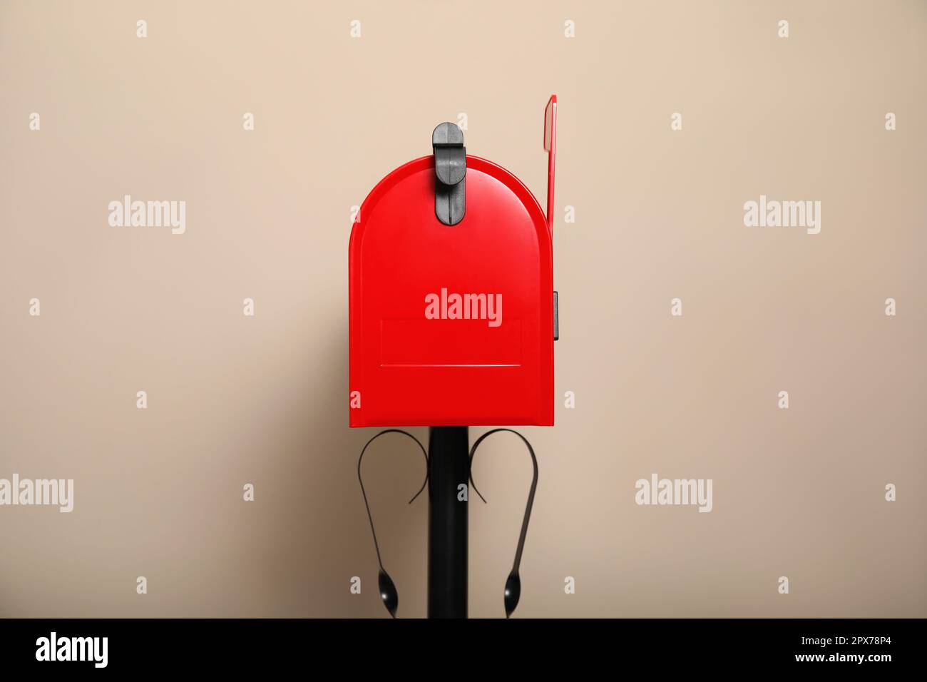 Closed red letter box against beige background Stock Photo - Alamy