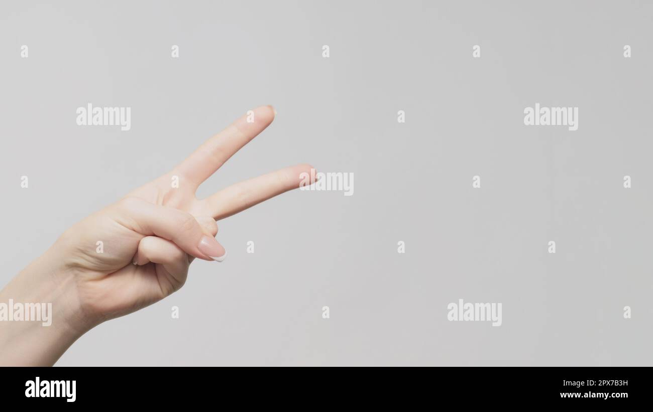 Hand gesture victory sign woman two fingers Stock Photo - Alamy
