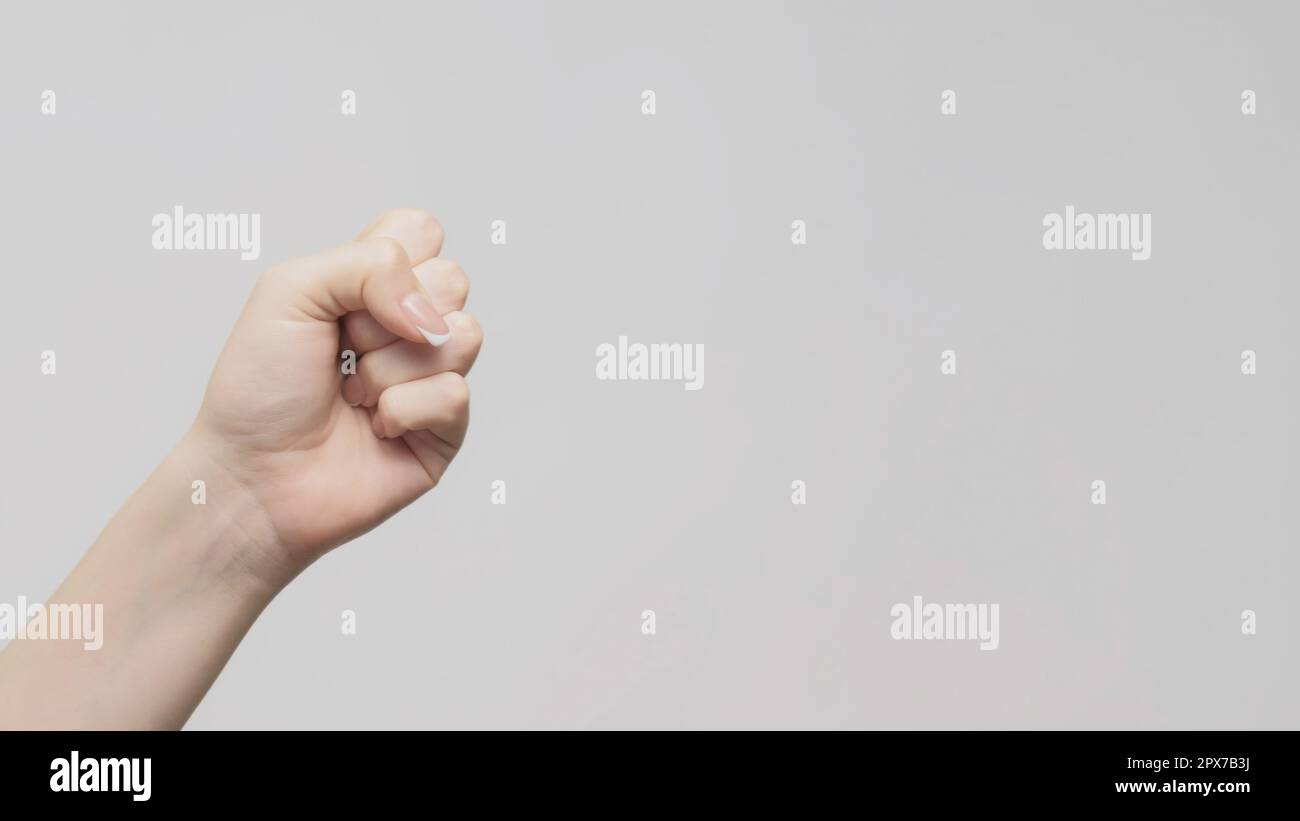 Threatening hand angry gesture female fist gray Stock Photo - Alamy