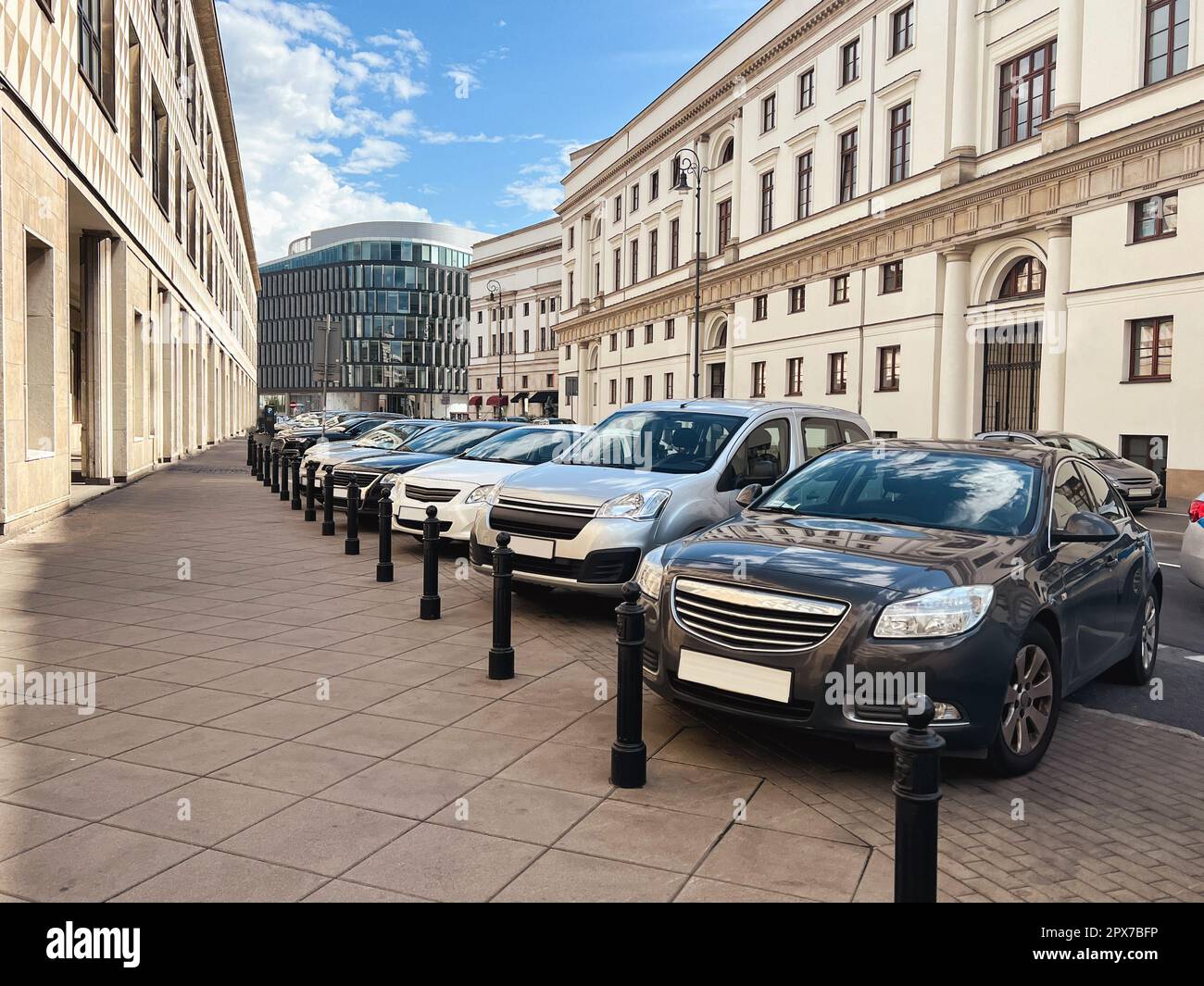 Different modern cars parked on city street Stock Photo - Alamy