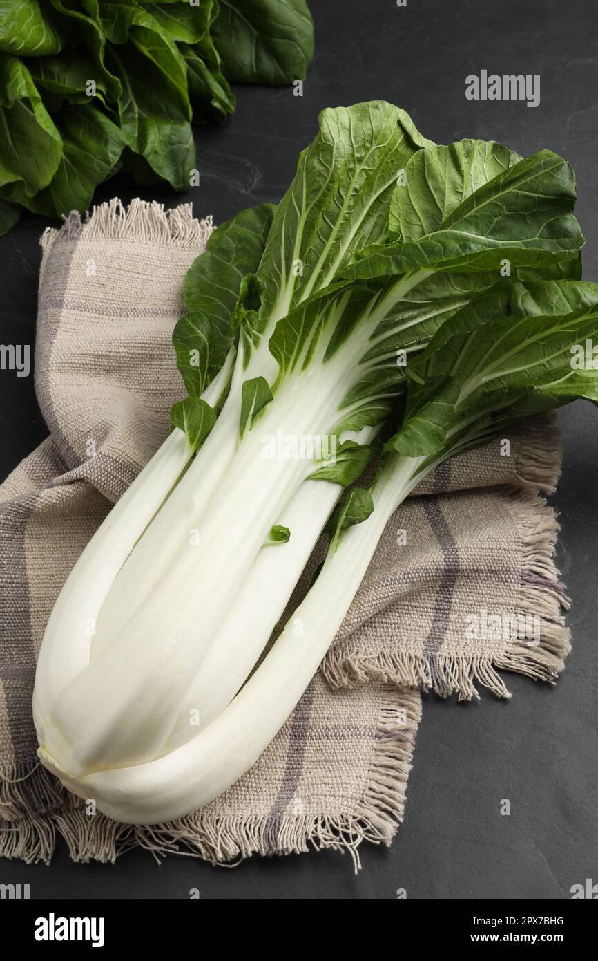 Fresh green pak choy cabbage on black table, above view Stock Photo - Alamy