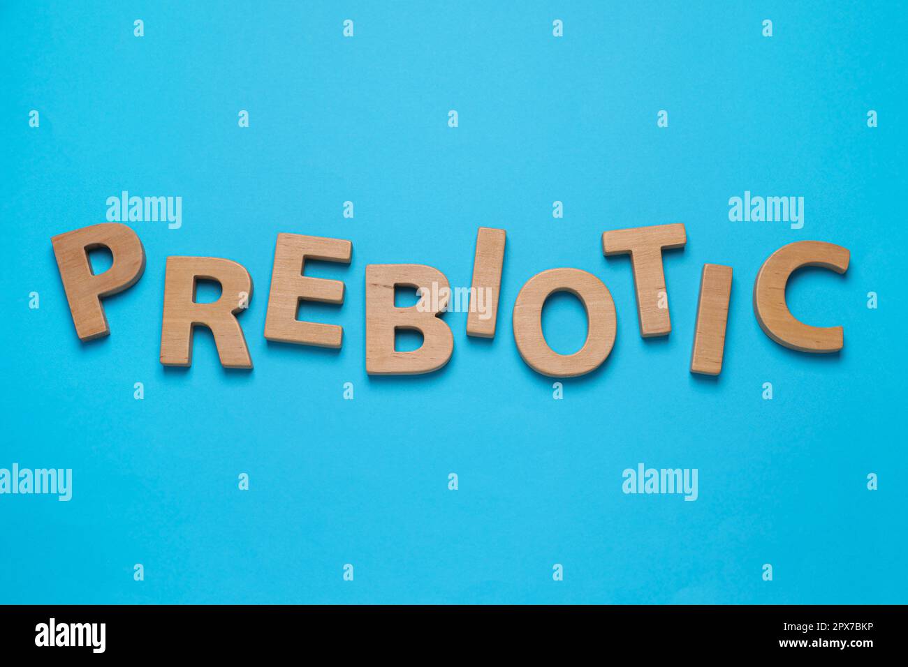 Word Prebiotic made of wooden letters on light blue background, flat ...