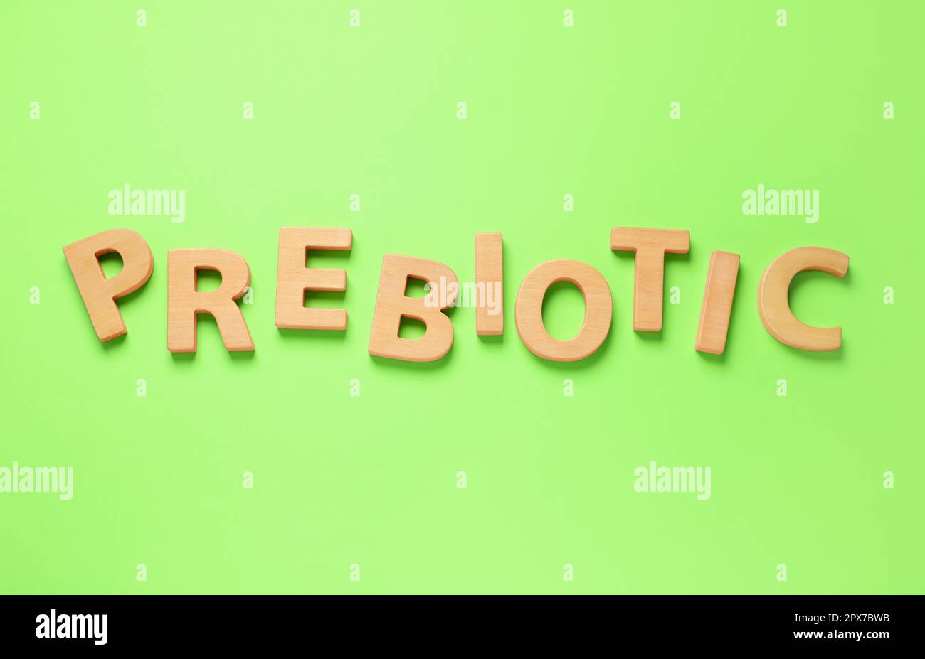 Word Prebiotic made of wooden letters on light green background, top ...