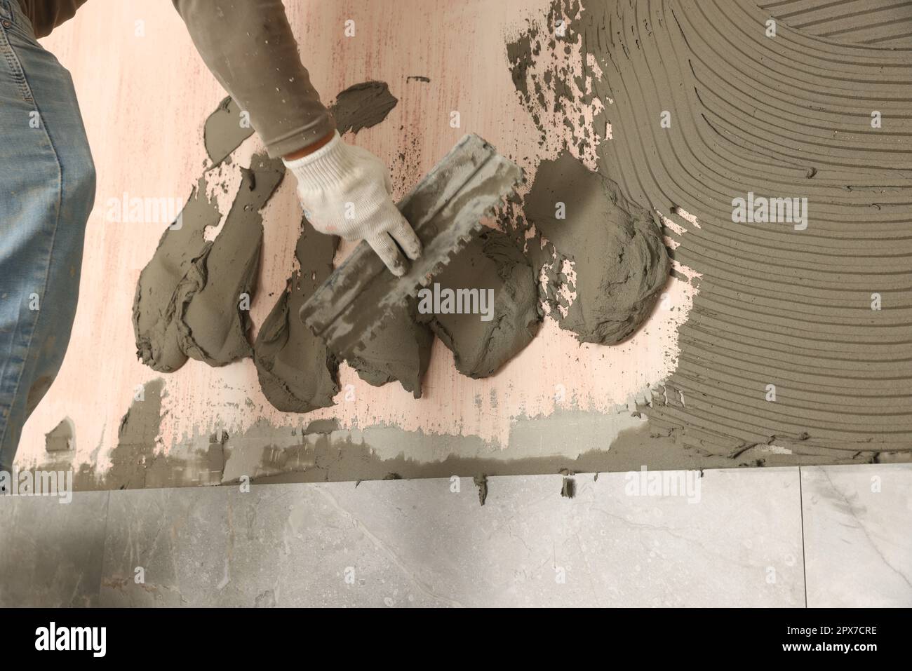 Worker applying cement on wall for tile installation, closeup Stock ...