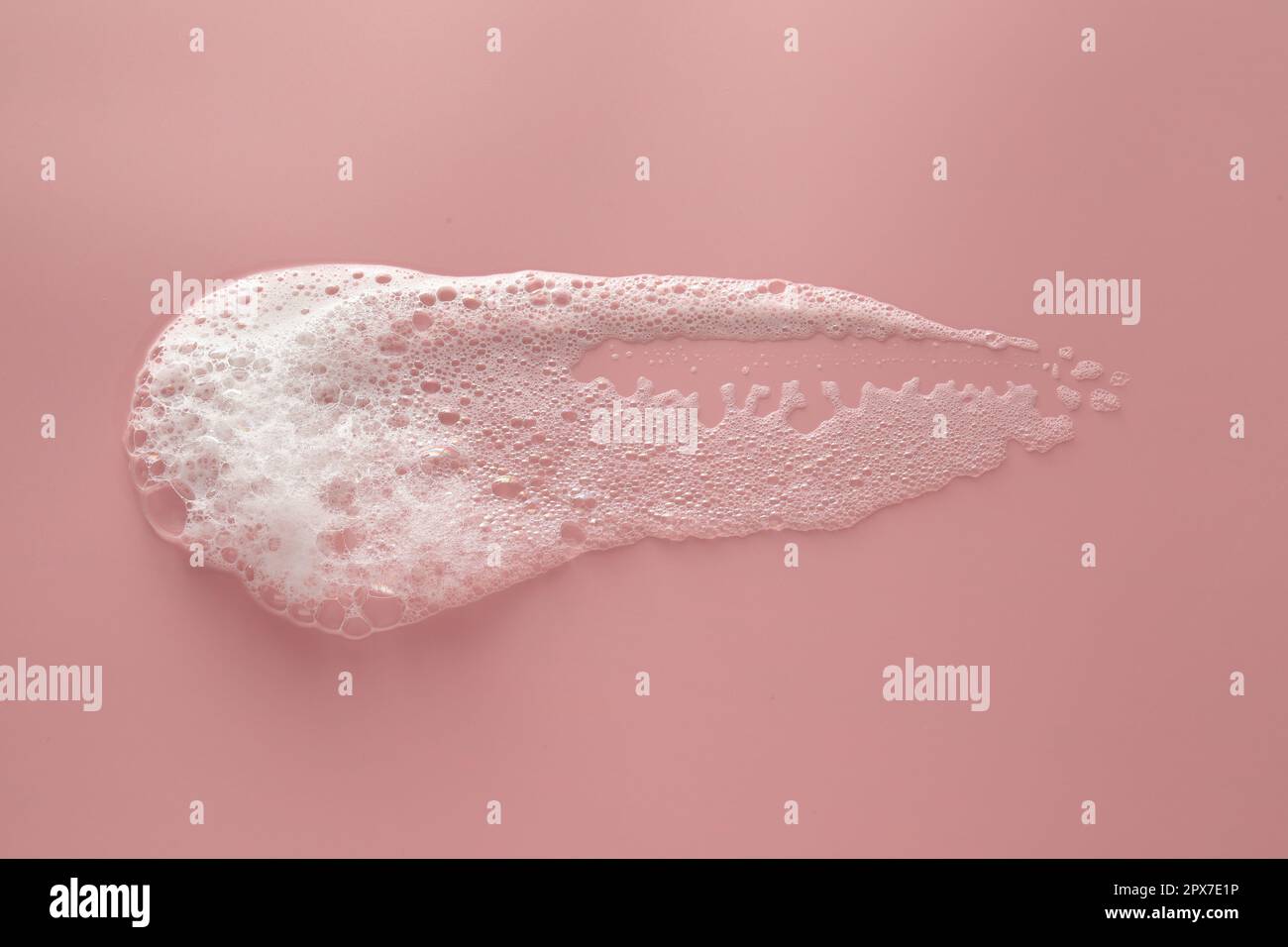 Smudge of white washing foam on pale pink background, top view Stock ...