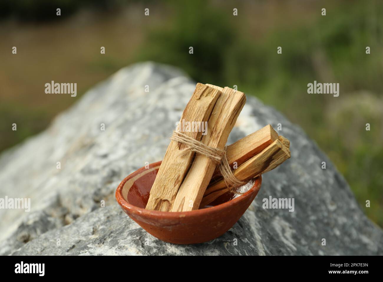 Many palo santo sticks on stone surface outdoors Stock Photo - Alamy