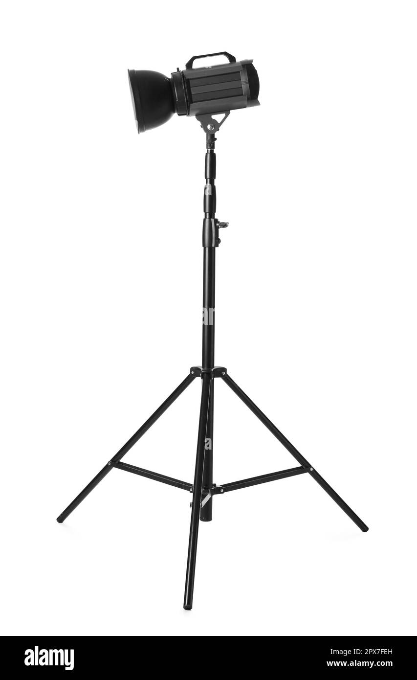 Studio flash light on tripod against white background. Professional ...