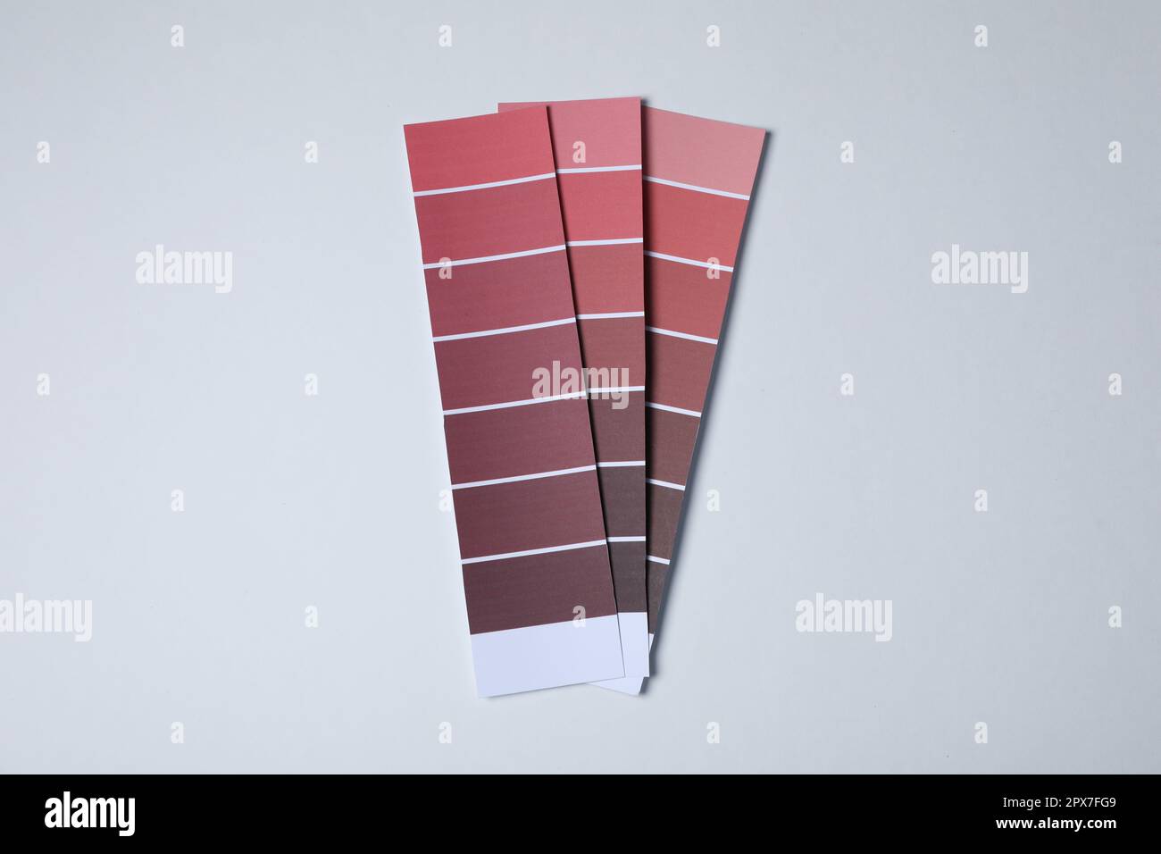 Color paint chips of red shades on light background, top view Stock ...
