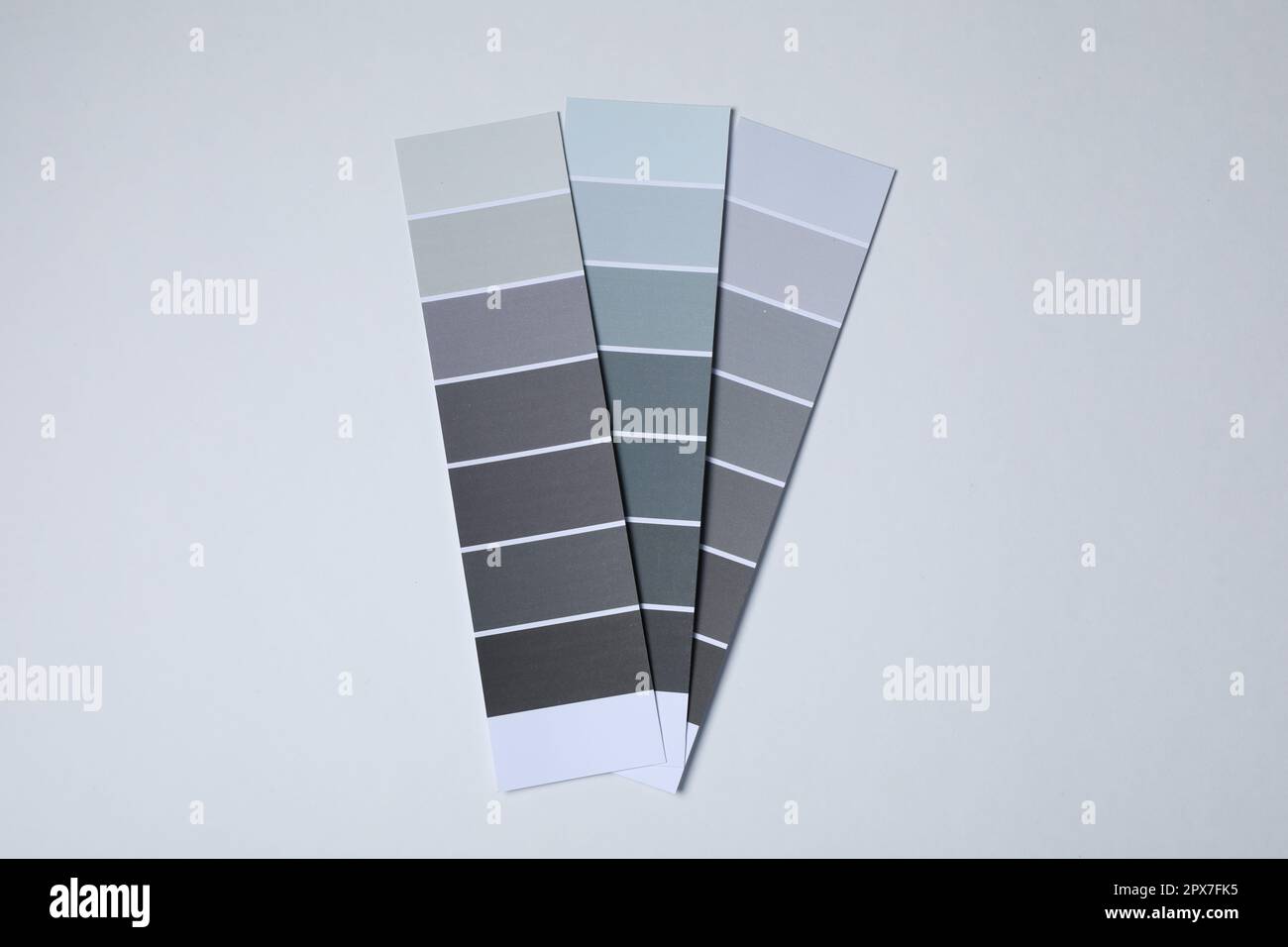 Color paint chips of grey shades on light background, top view Stock ...