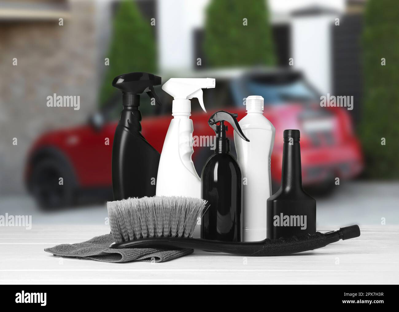 Cleaning supplies on white wooden surface at car wash Stock Photo - Alamy