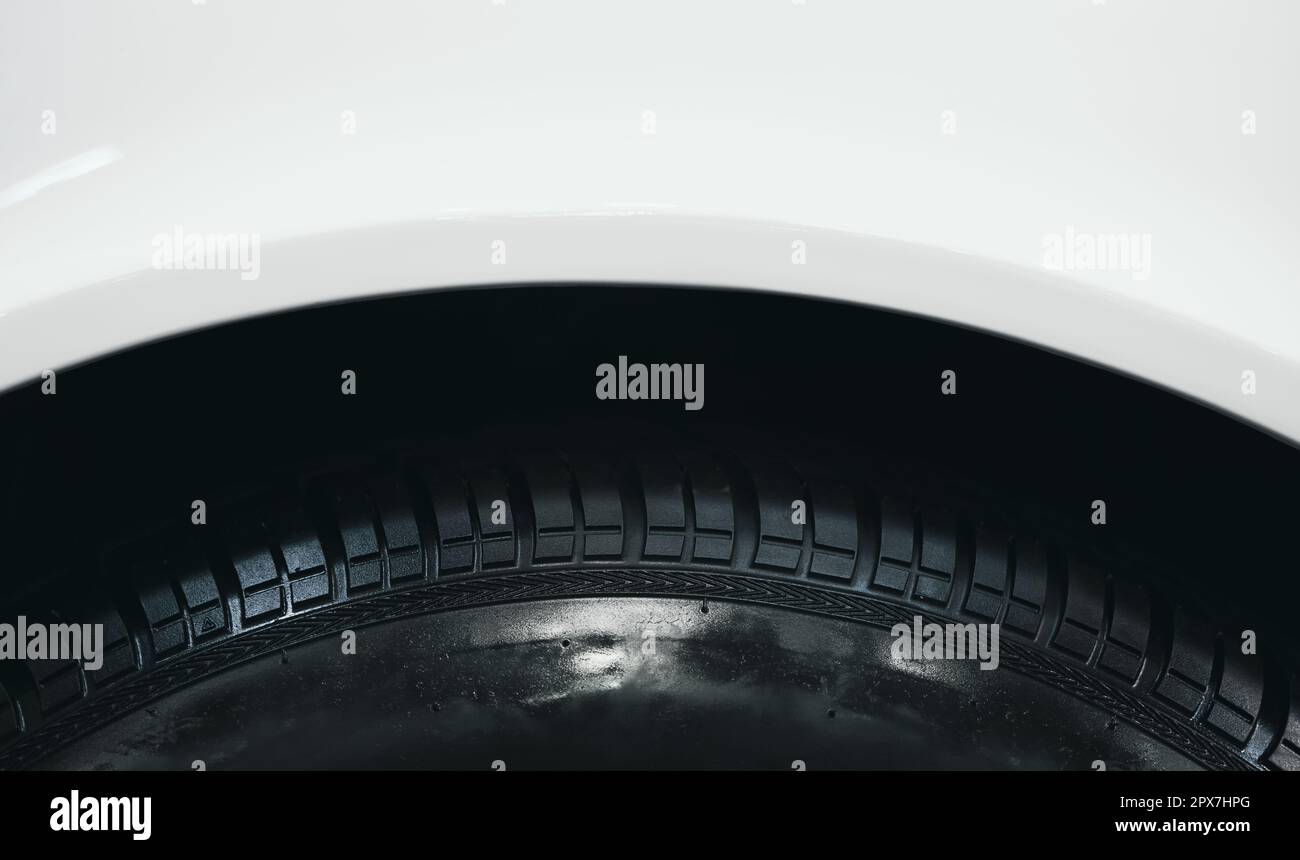 front view detail of car wheel black rubber tire on the front wing ...