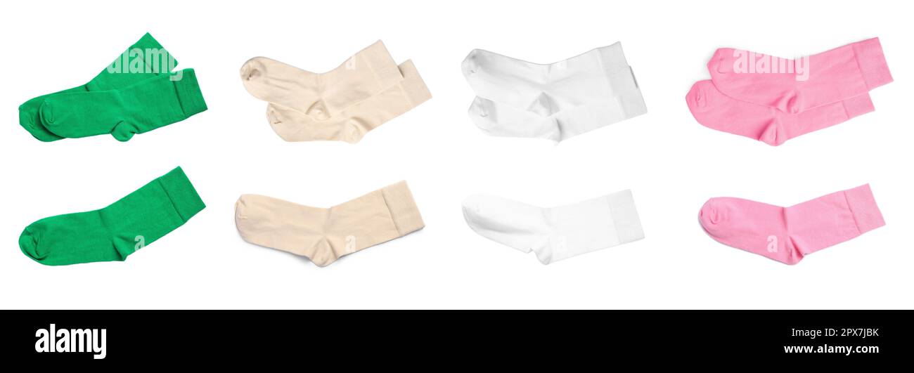Set with pairs of different color socks on white background, top view ...