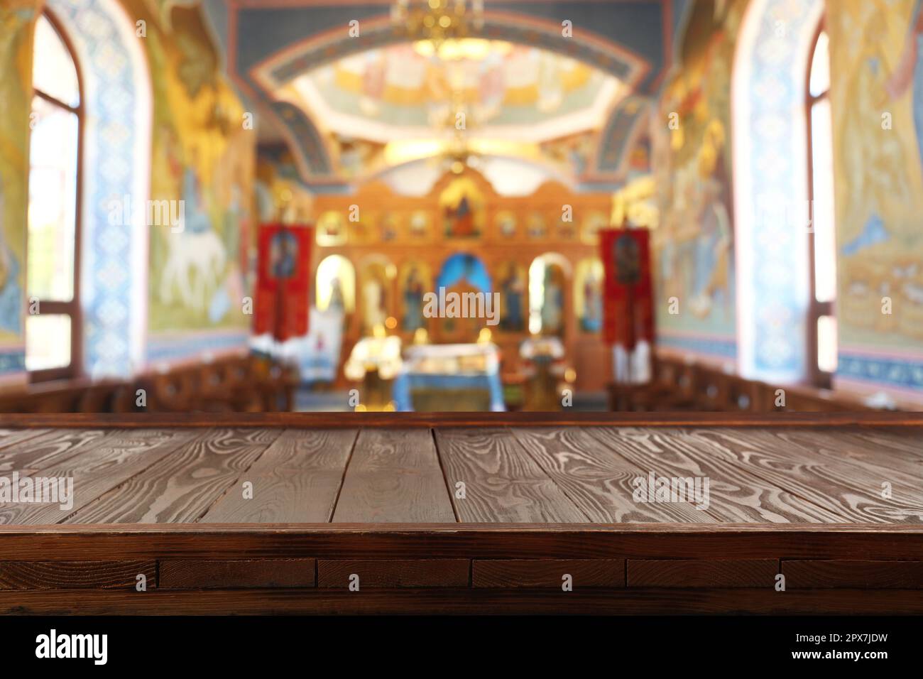 Empty wooden table and blurred view of beautiful church interior, space ...