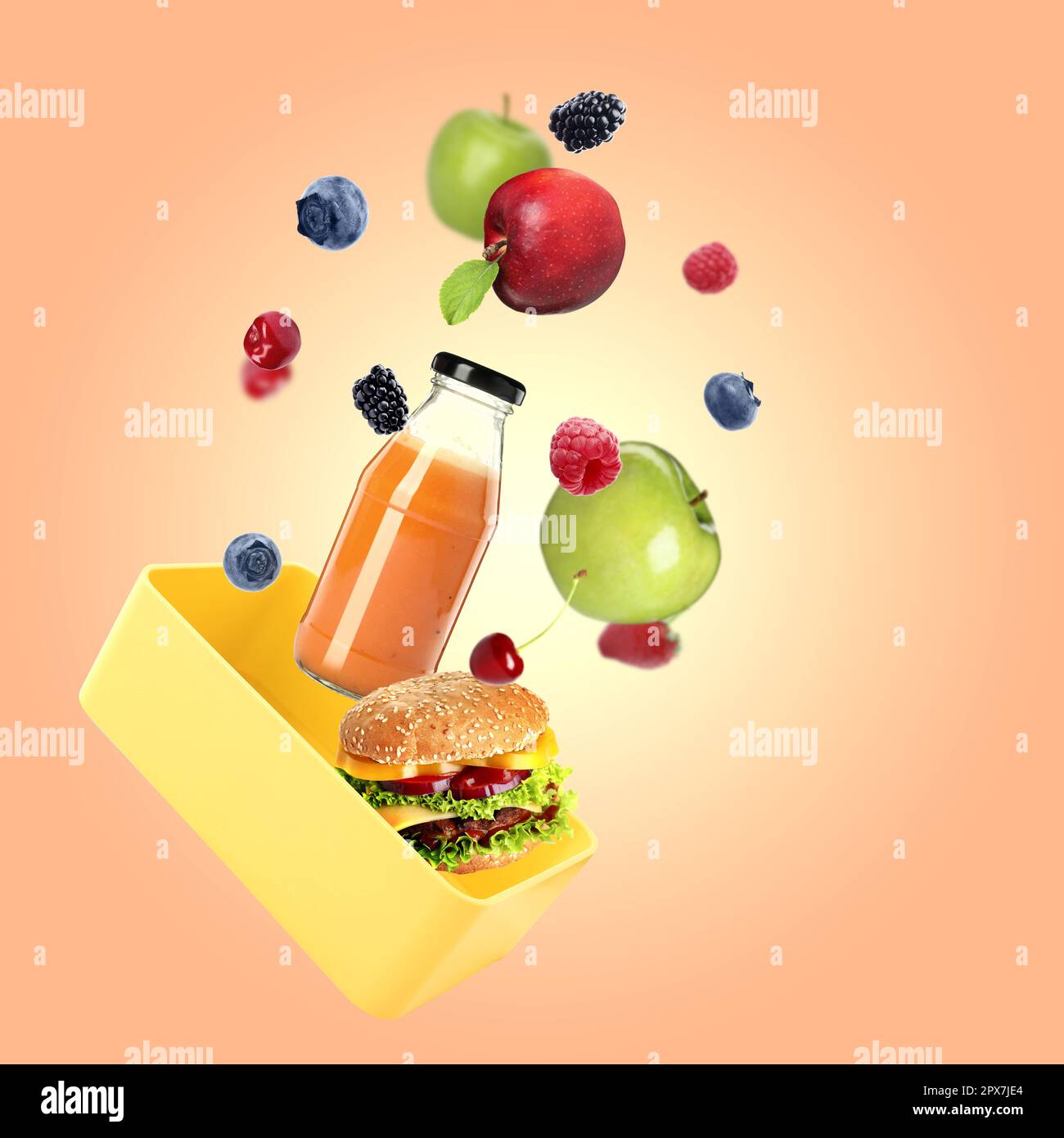 Different fresh food falling into lunch box on orange background ...