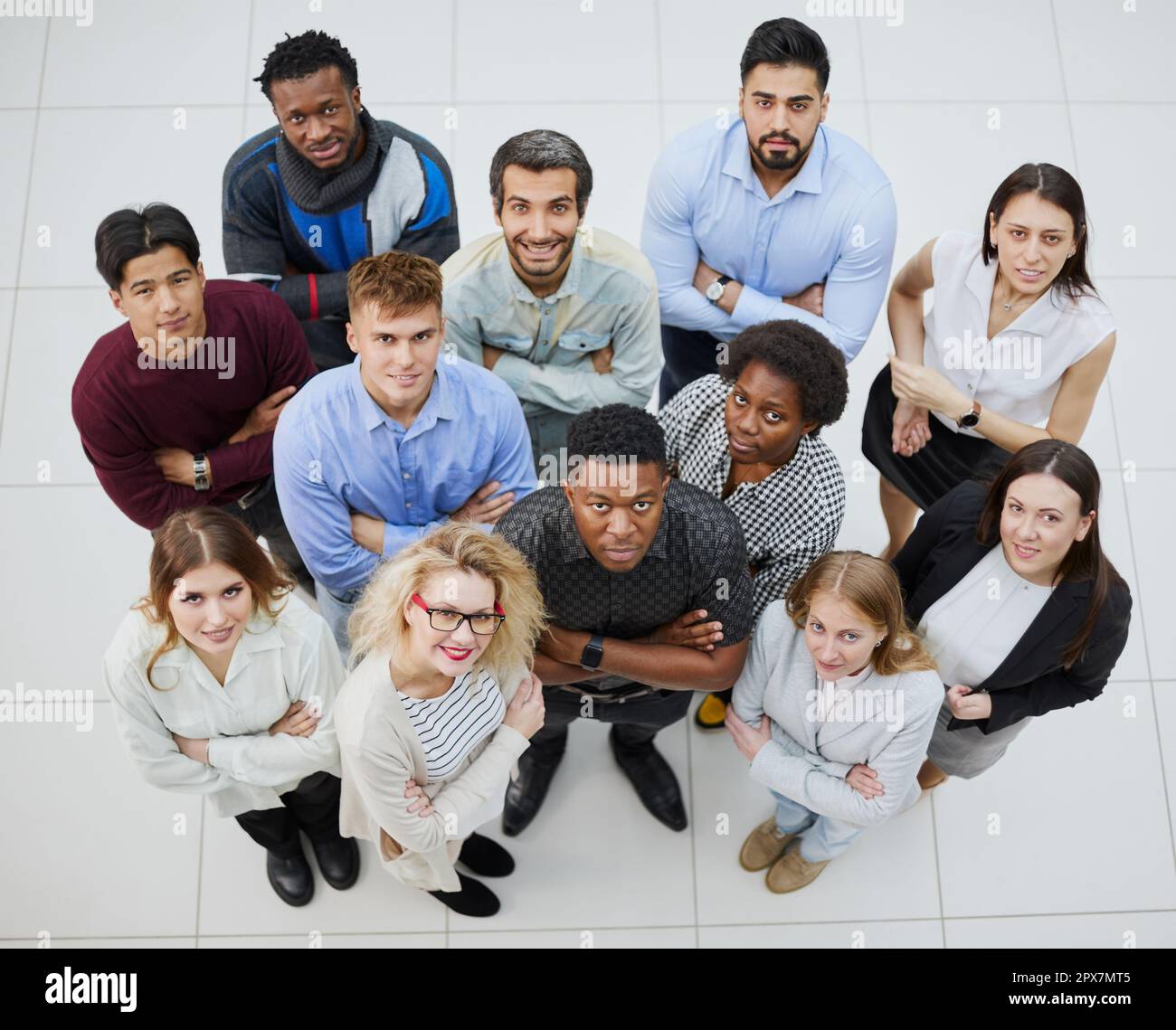 large group of diverse young people looking up hopefully Stock Photo ...