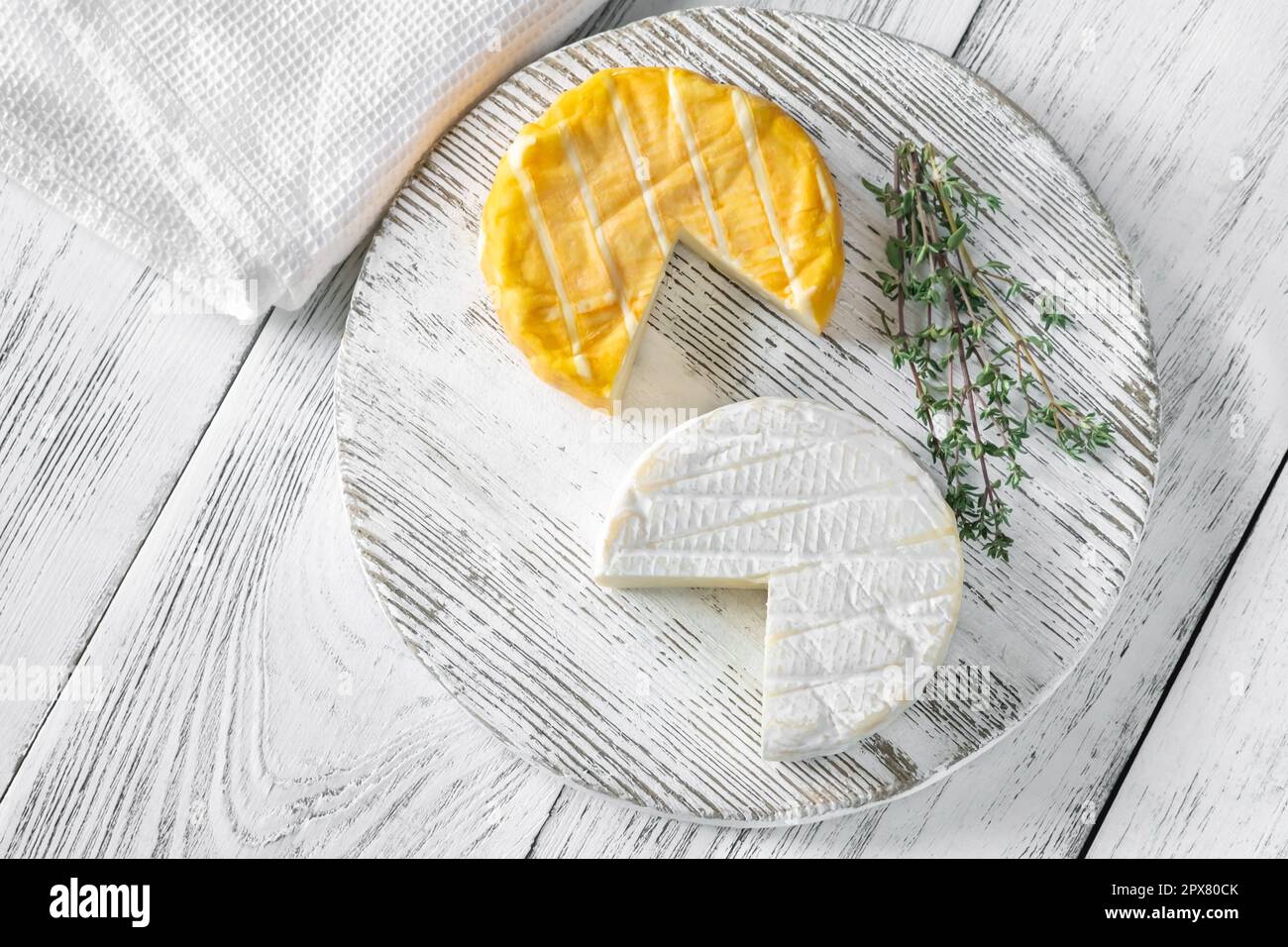 Two camembert cheese wheels on the cutting board Stock Photo - Alamy