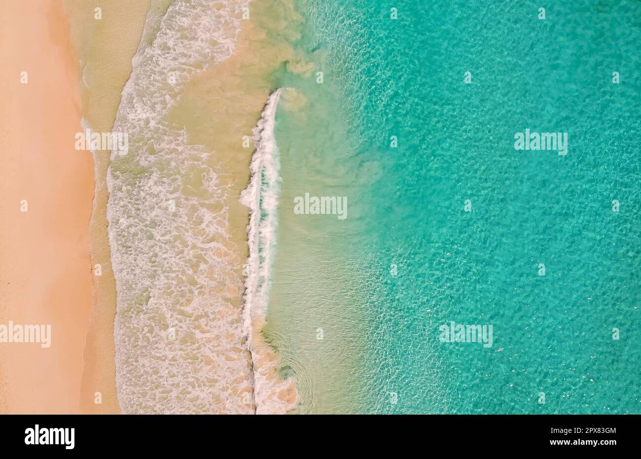Aerial Top view of a transparent blue sea with beautiful waves at sunny ...