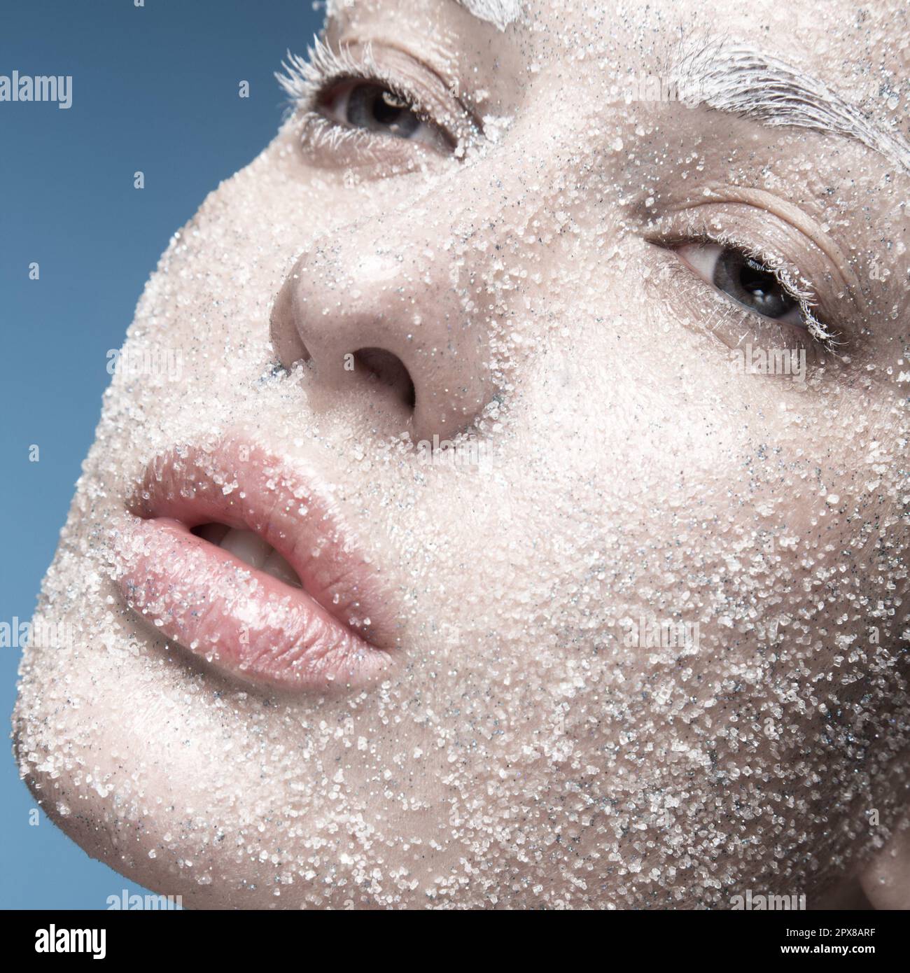 Portrait of a girl with pale skin and sugar snow on her face. Creative ...