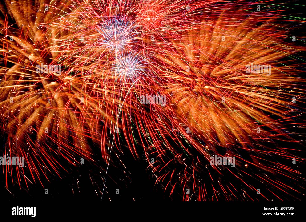 A colorful high-altitude fireworks display in the night sky with ...