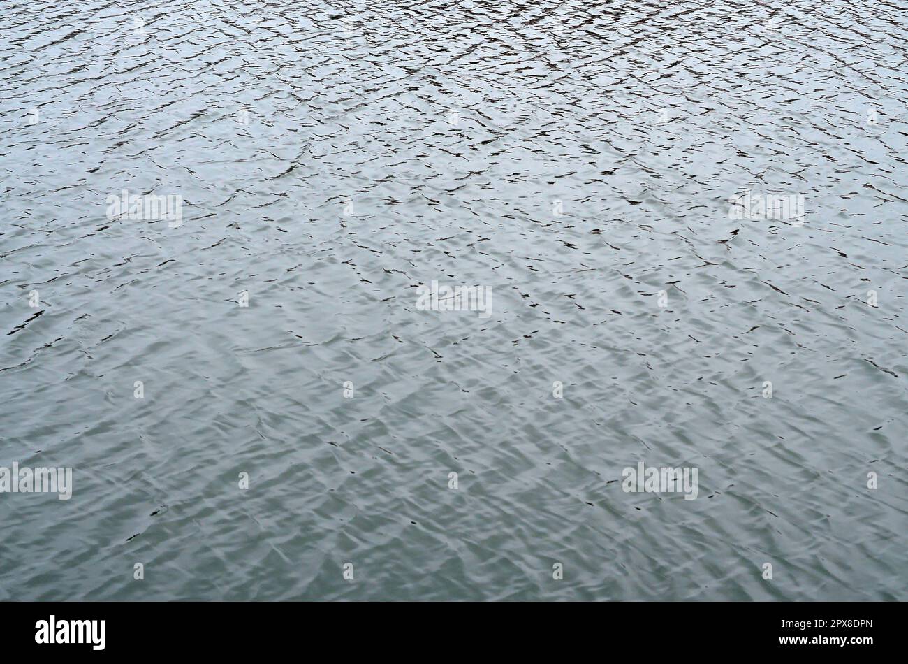The texture of the water in the river under the influence of wind. A ...