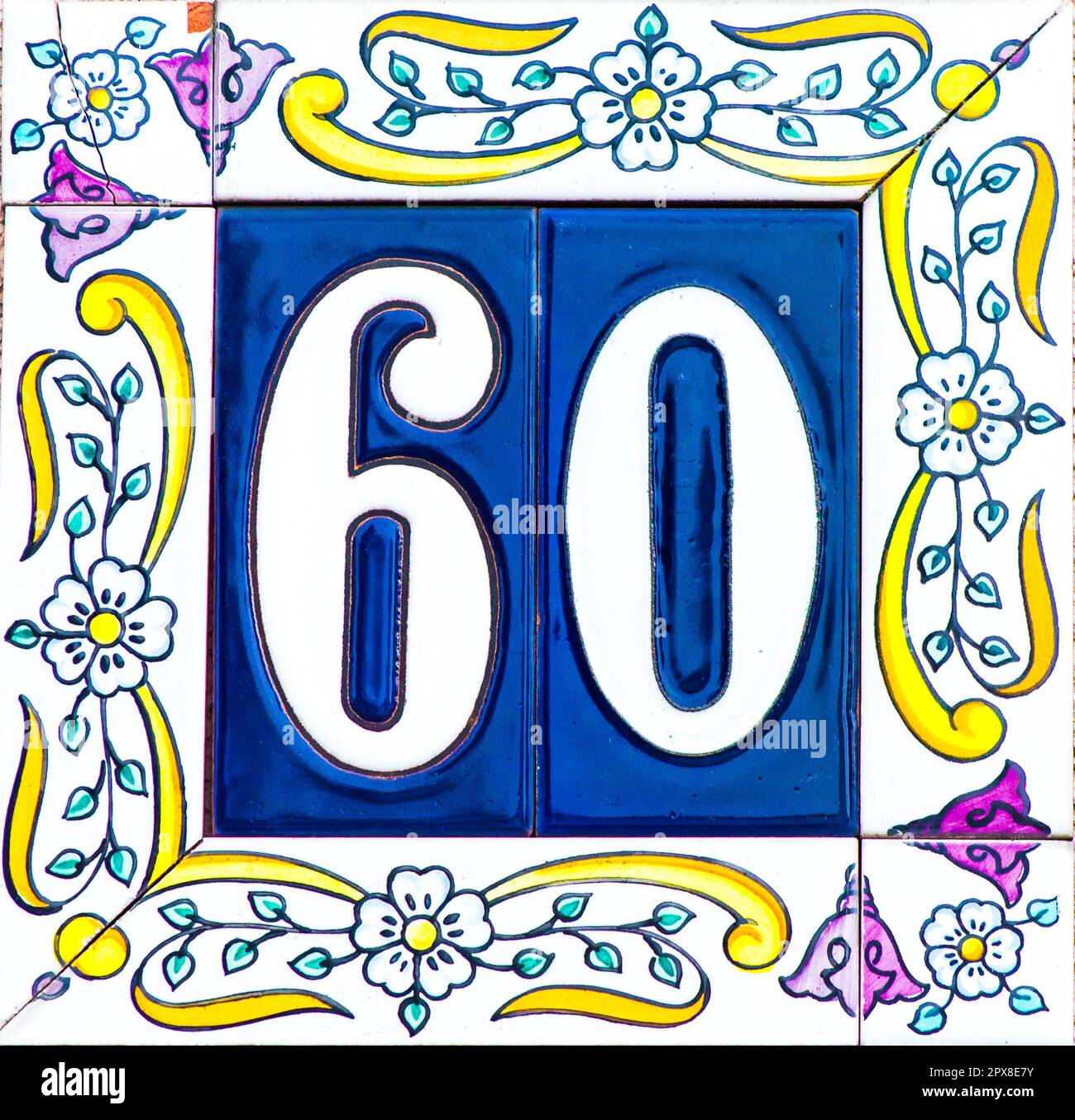Close up of a house number 60 on enameled colorful tiles with ...