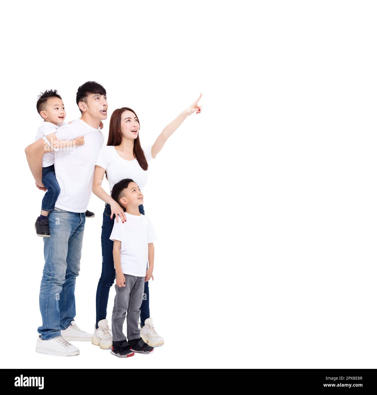 Happy family standing and looking up Stock Photo - Alamy