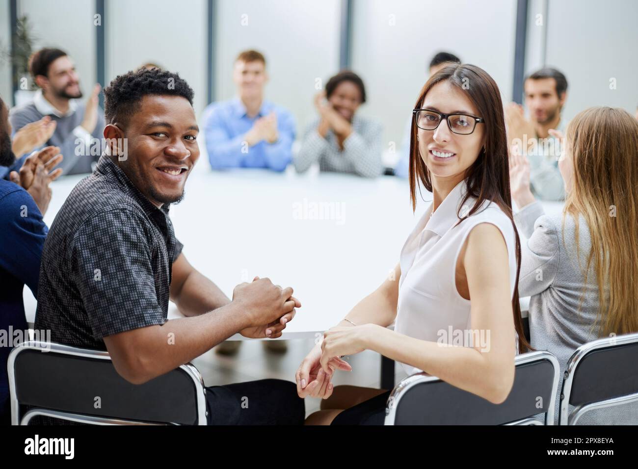 girl posing for the camera sitting at a round table Stock Photo - Alamy