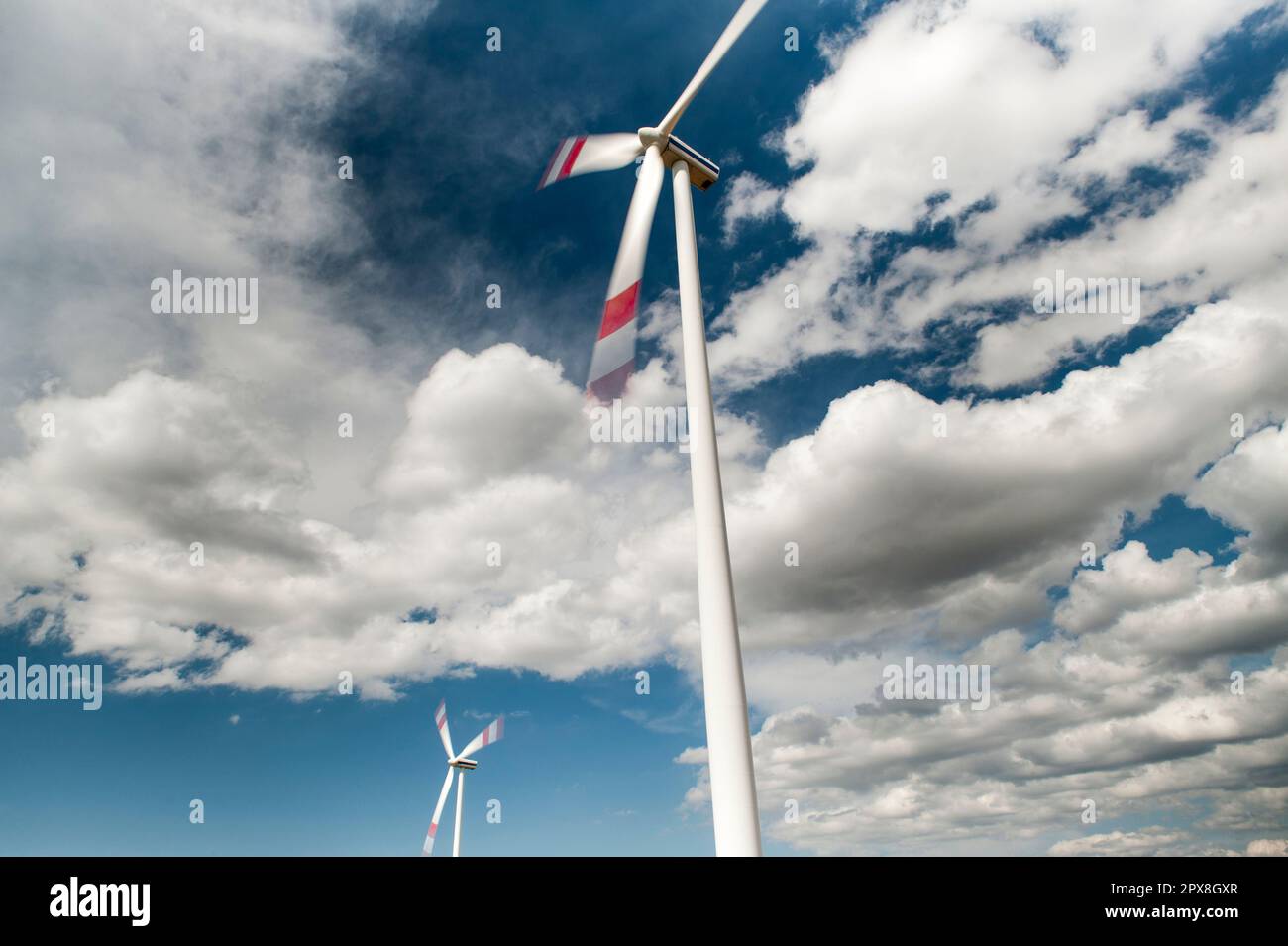 The rotor blades of a wind turbine, blurred by the rotation, in the ...