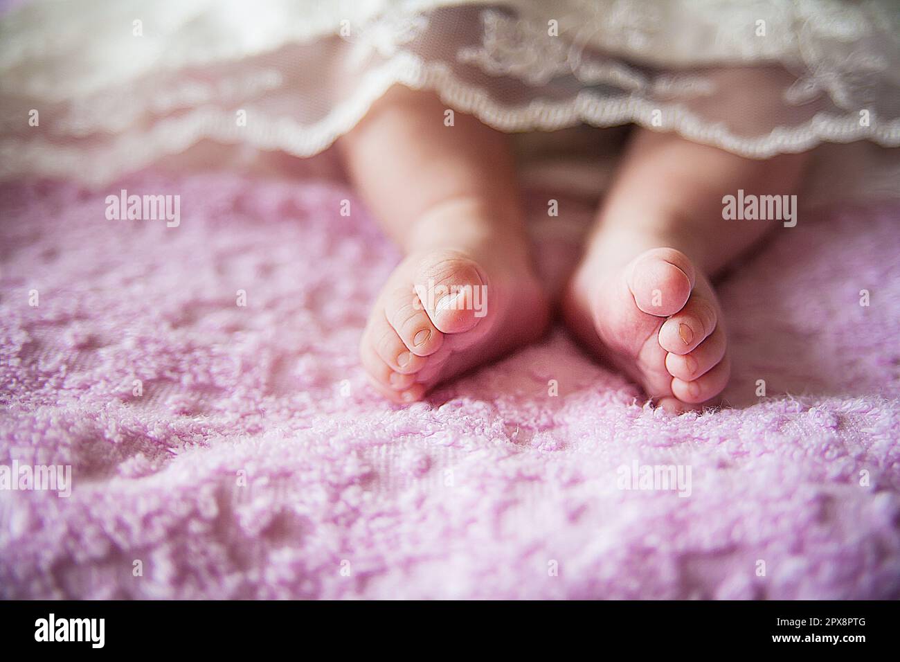 little girls legs under white lace cloth Stock Photo - Alamy