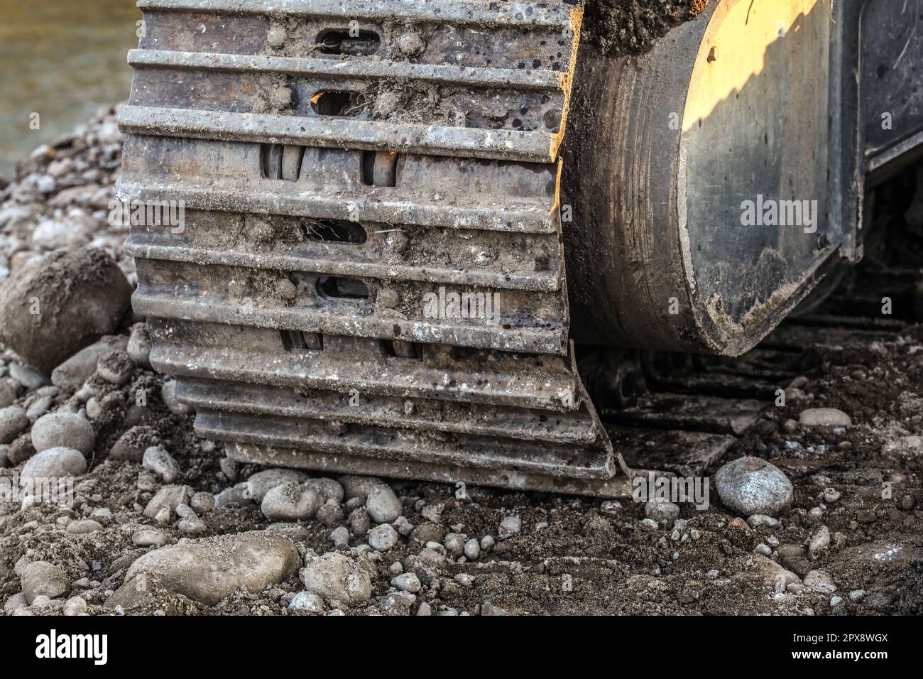 Detail of metal digger track on stones and sand ground. Construction ...