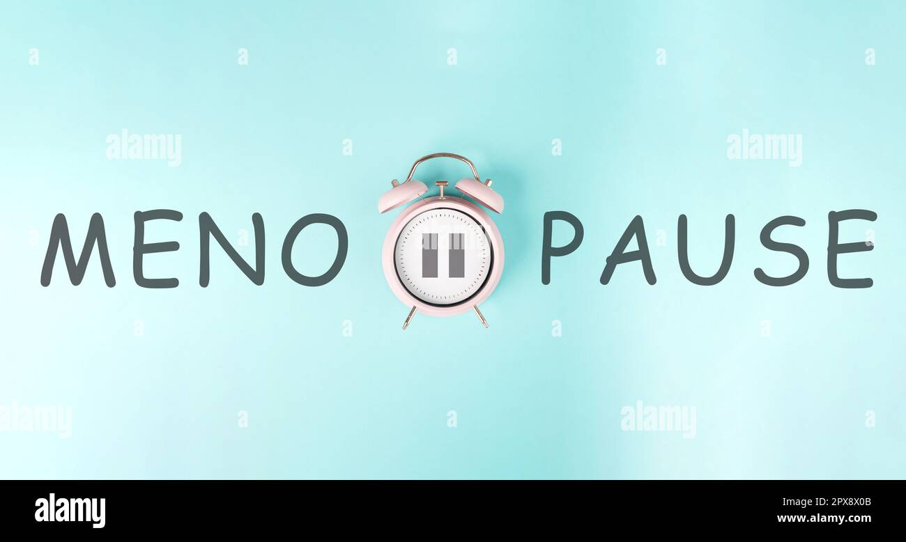 Alarm clock with pause sign and the word menopause, hormone replacement ...