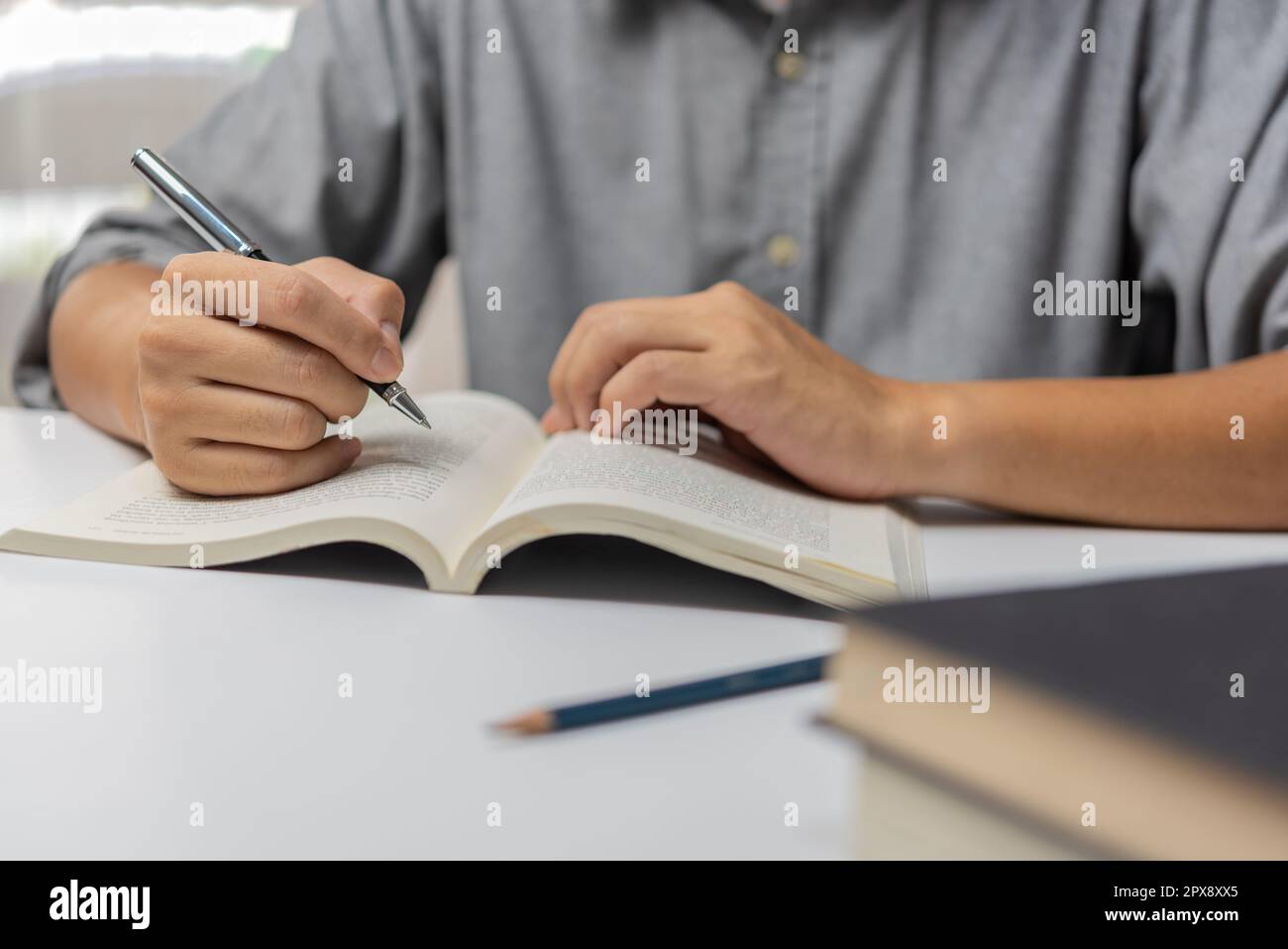 Businessperson reading and writing on book.education studying knowledge ...