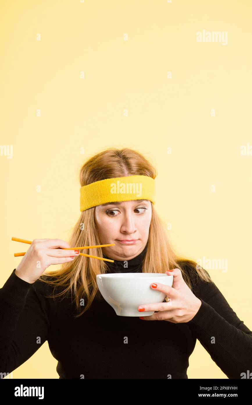 I have no idea how to use chopsticks. an attractive young woman ...