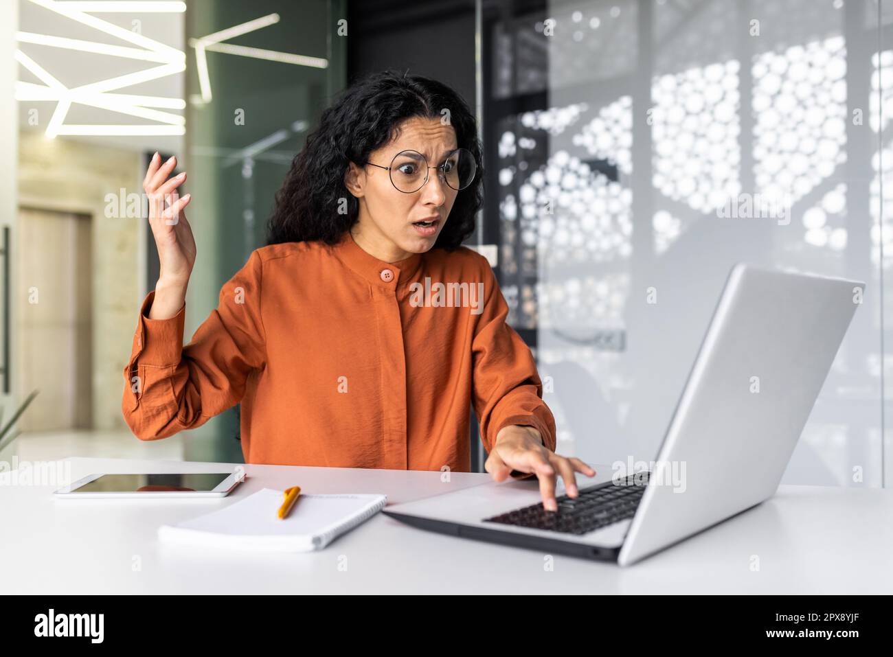 Upset and nervous business woman looking at laptop screen, female ...