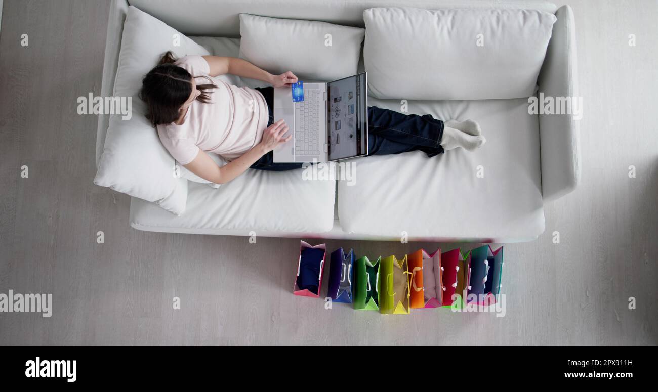 Online Laptop Shopper On Sofa. Top View Stock Photo - Alamy