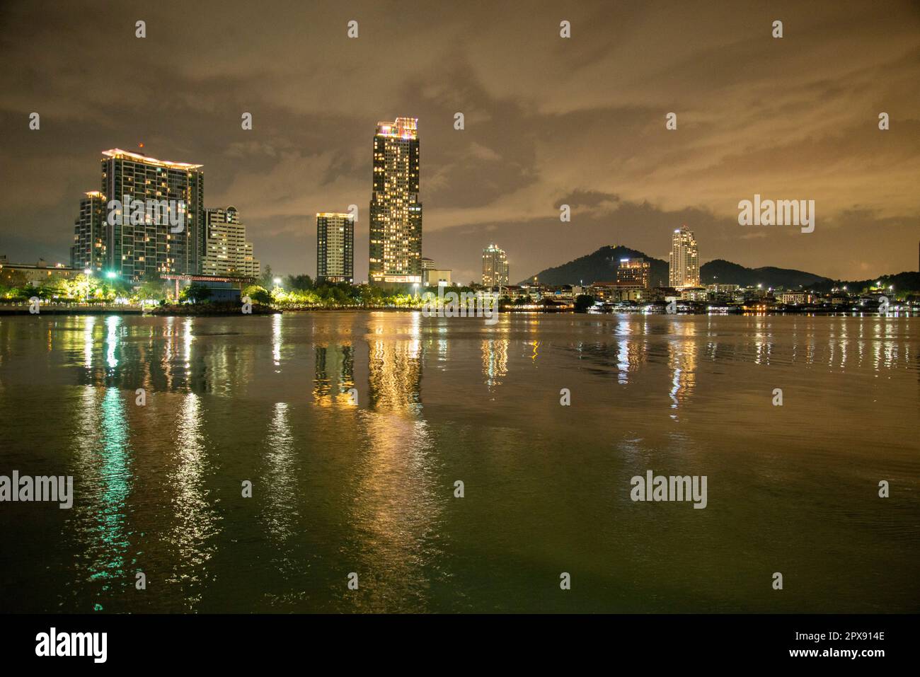 the skyline at night of the City of Si Racha in the Province of ...