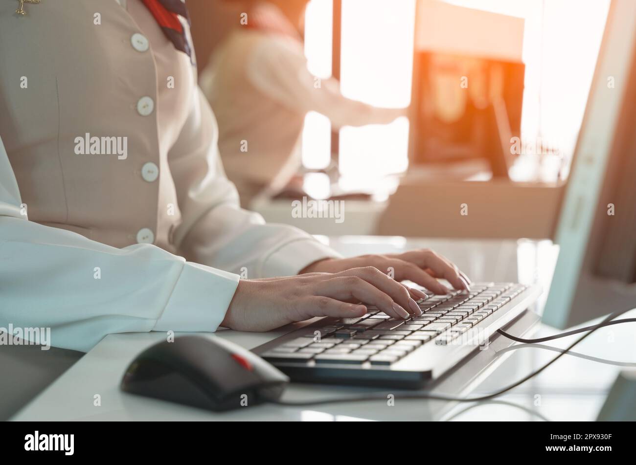 Female officers working at airline check in service counter. Close up ...