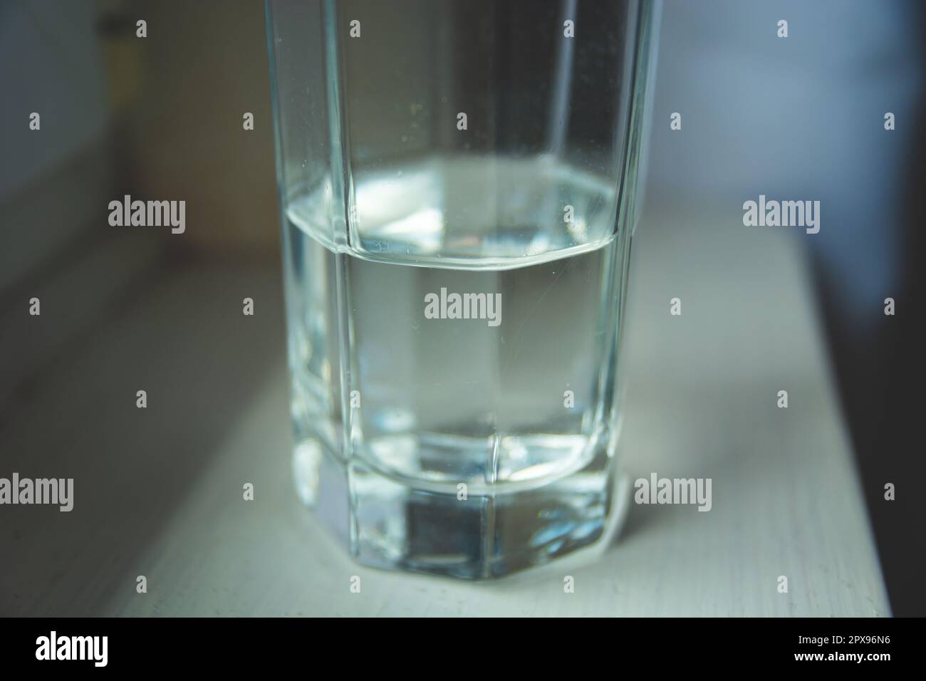 Half glass of water standing on the kitchen counter Stock Photo - Alamy