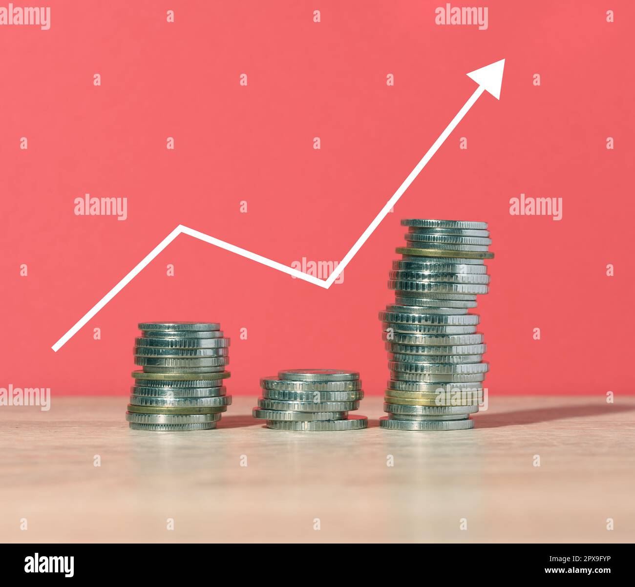 A stack of metallic coins and a graph on a red background. Income ...