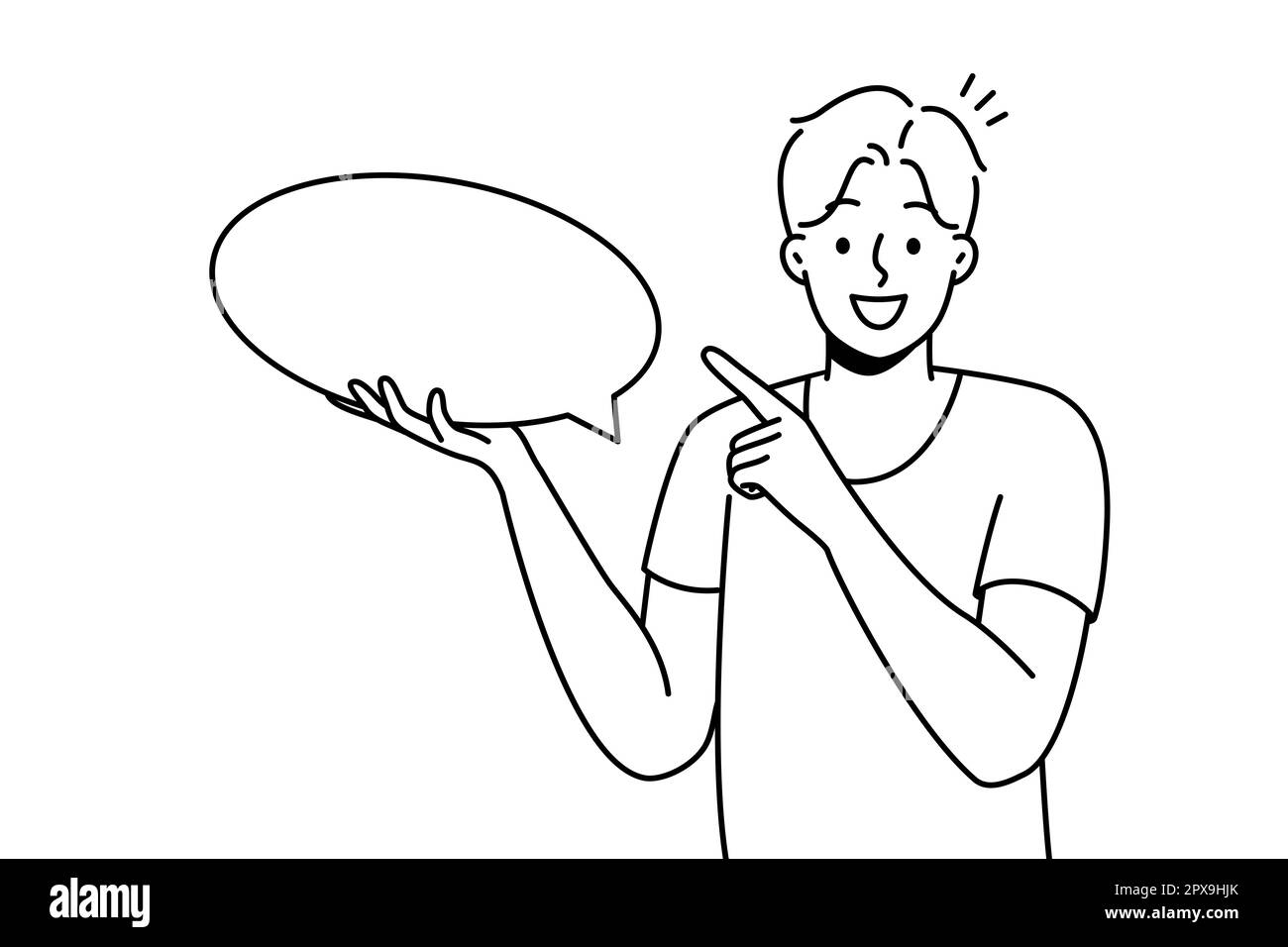 Smiling young man holding speech bubble in hands. Happy guy point at ...