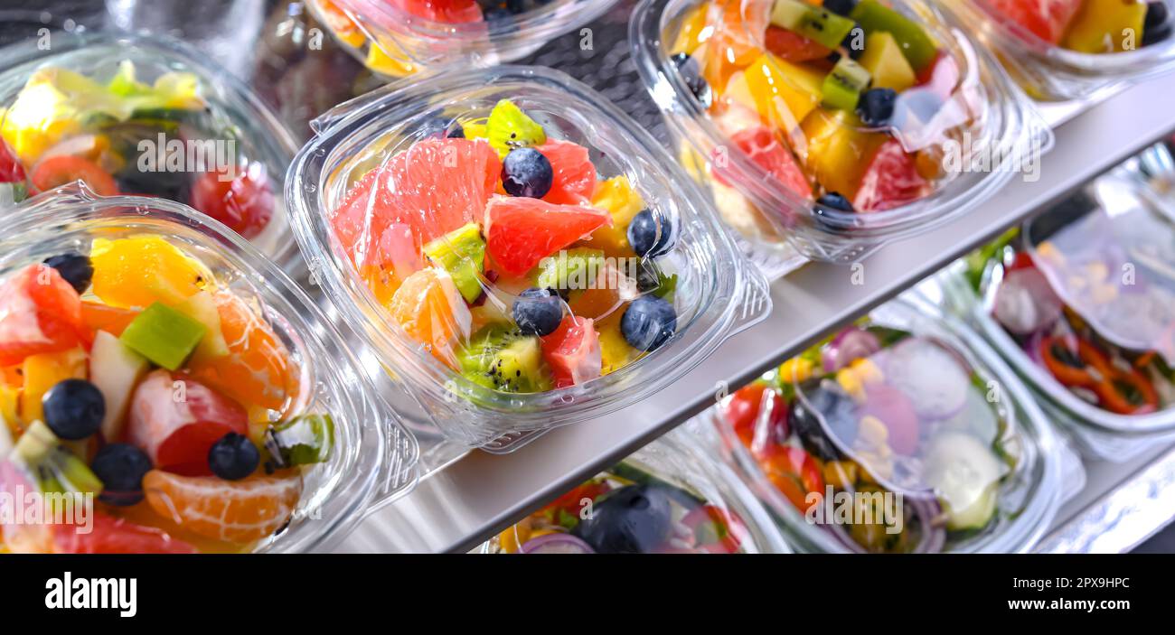 Plastic boxes with pre-packaged fruit salads, put up for sale in a ...