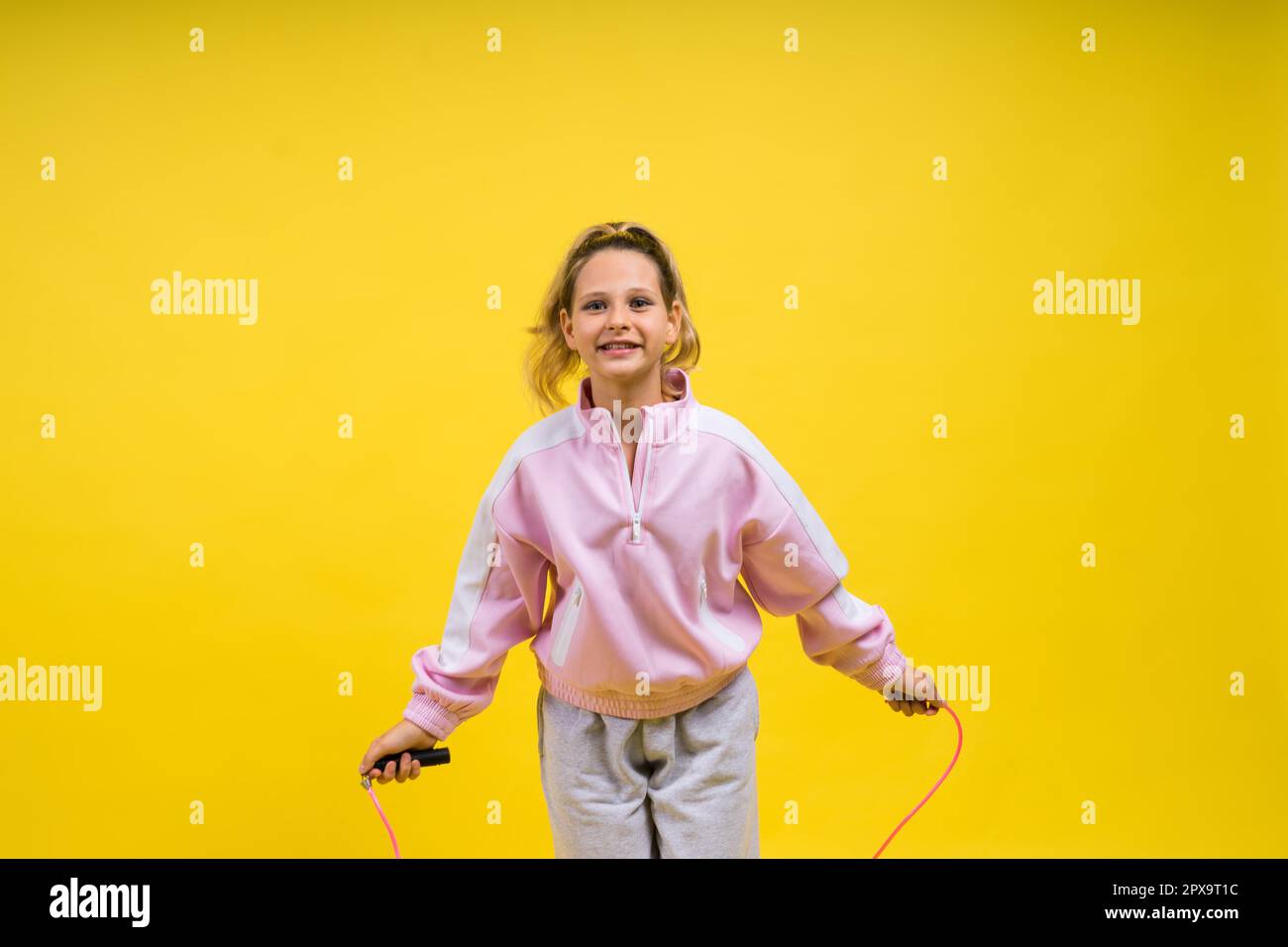 Adorable female child with skipping rope jumping in a studio Stock ...