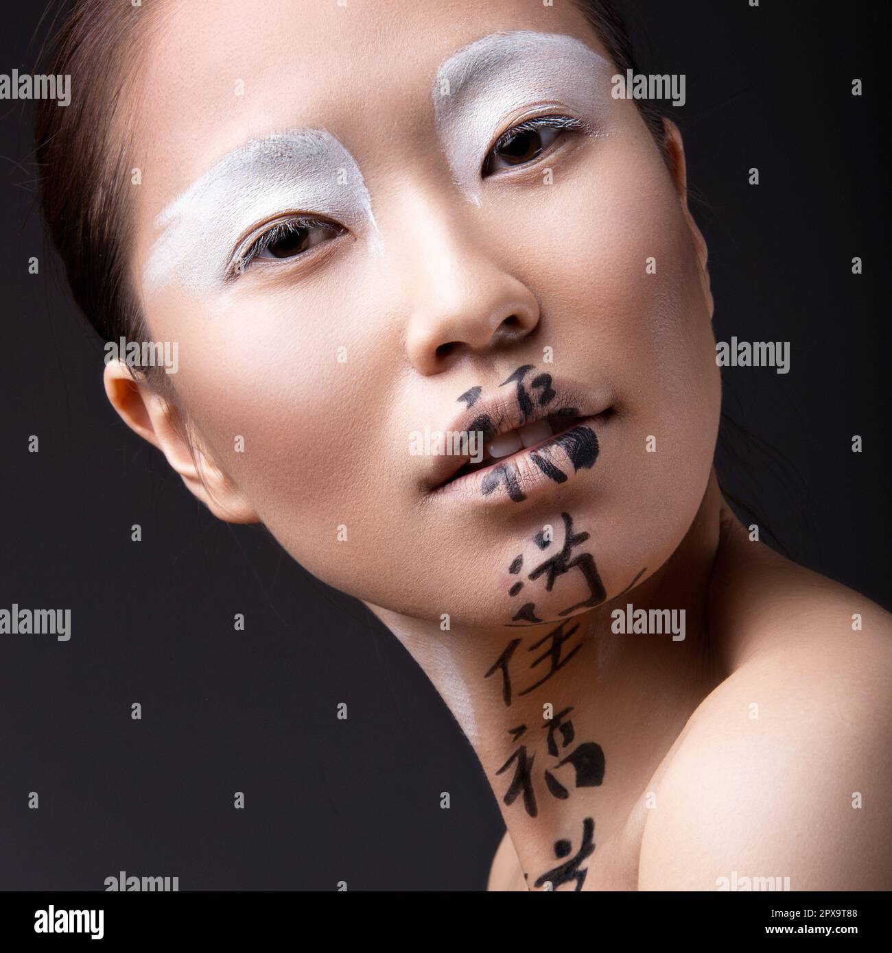 Beautiful Asian girl with white skin, red lips and hieroglyphics on her ...