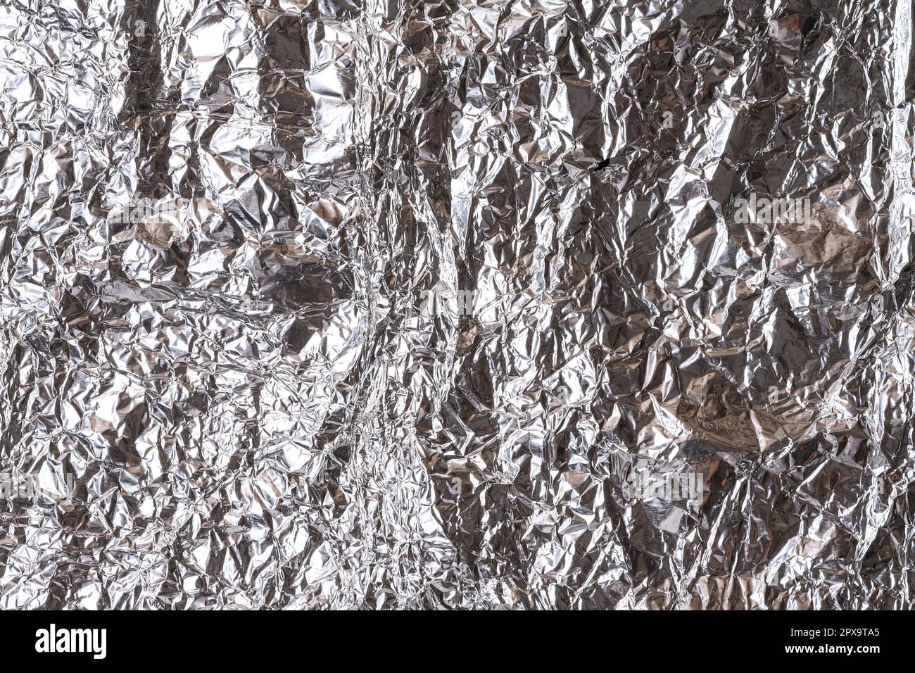 Crumpled sheet of gray foil, packaging material Stock Photo - Alamy