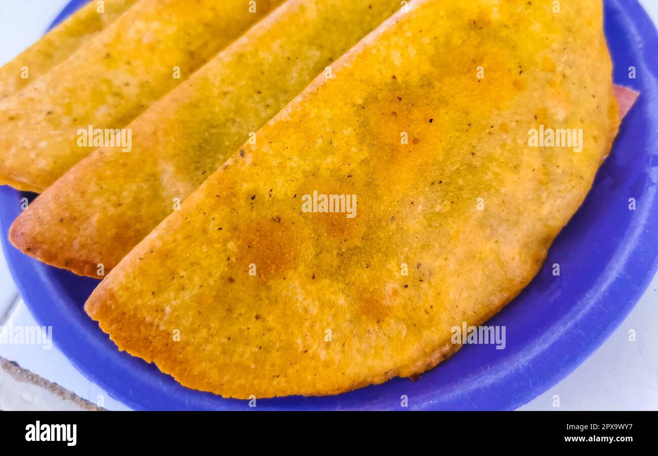 Mexican empanada on blue plate white background from Playa del Carmen ...