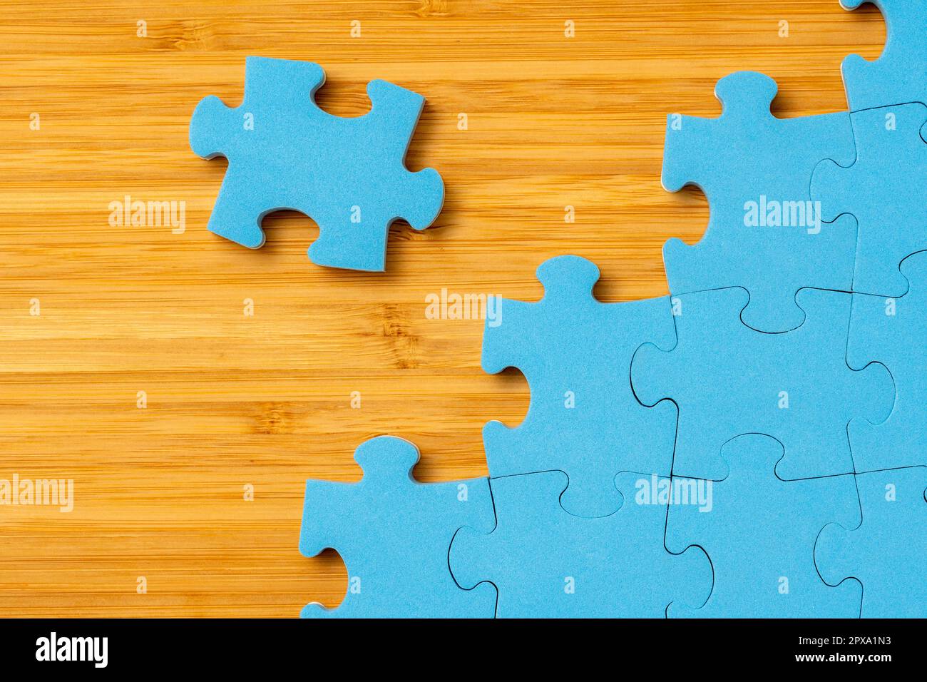 Blue puzzle pieces on wood table background. Business solutions ...