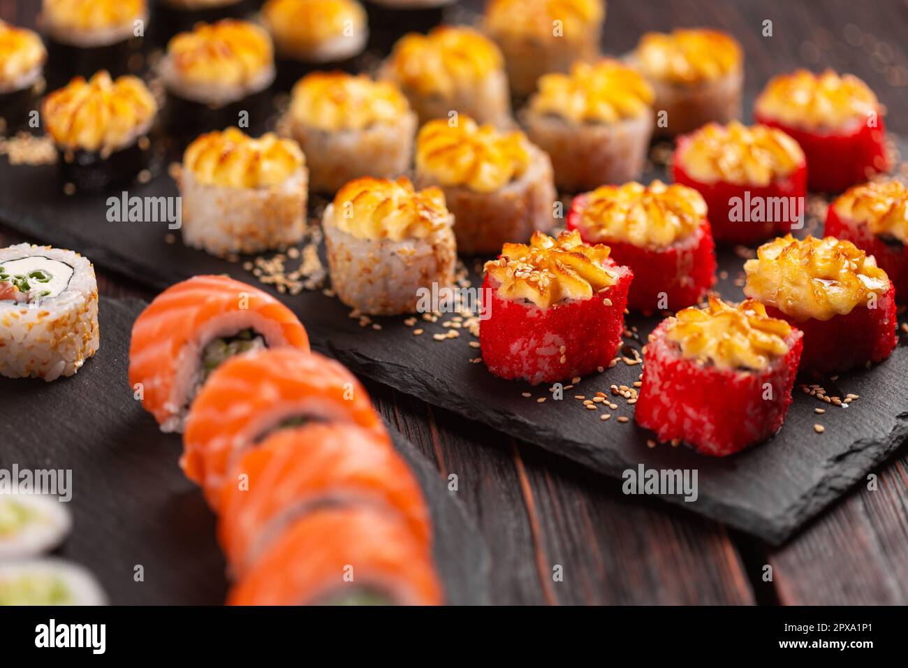 Large sushi set from top on black background. Assortment of various ...